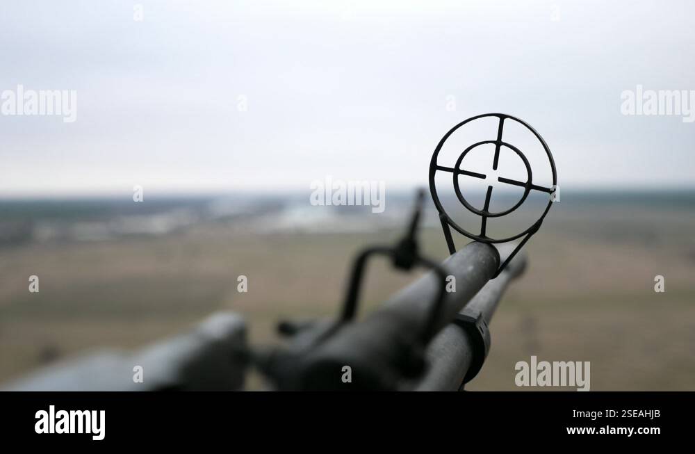 12.7mm machine gun front sight trembling in a soaring helicopter in ...