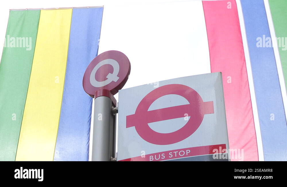 London bus stop sign with flags surrounding it Stock Video Footage - Alamy