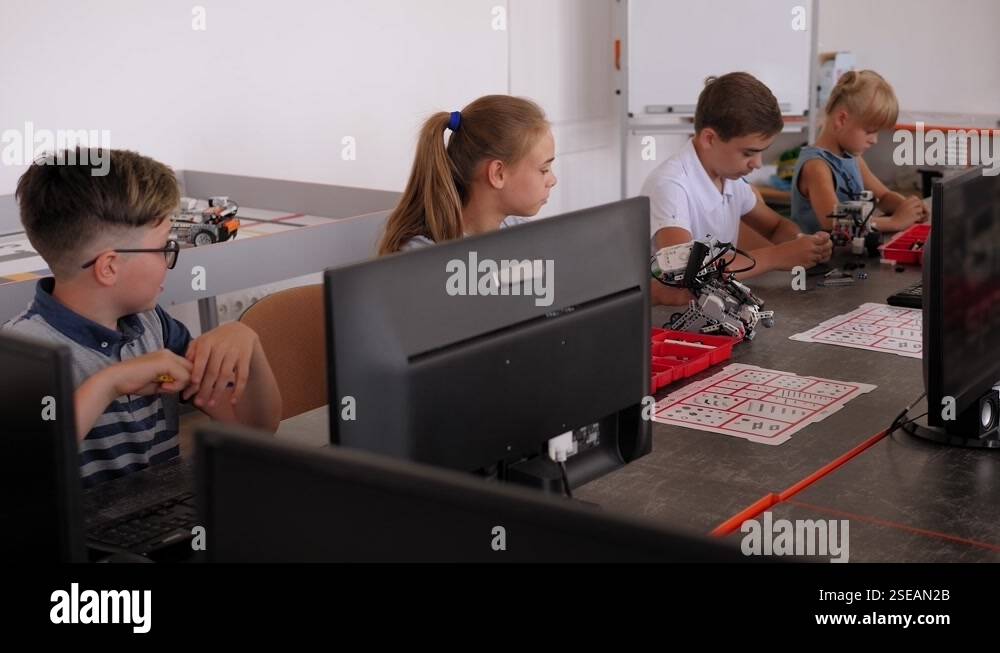 Group of children are making robots from the constructor in School of ...