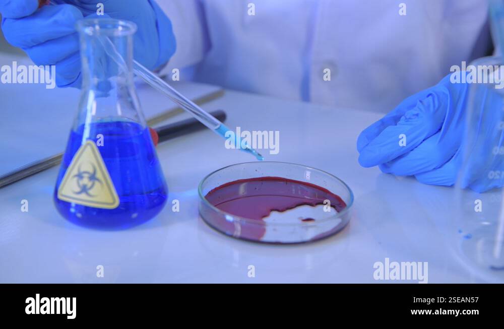 Research concept of 4k resolution. A scientist dripping liquid into a ...