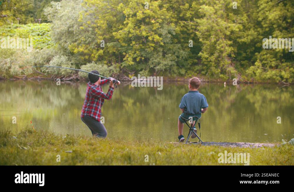 Two brothers on fishing - big brother throws fishing rod in the lake ...