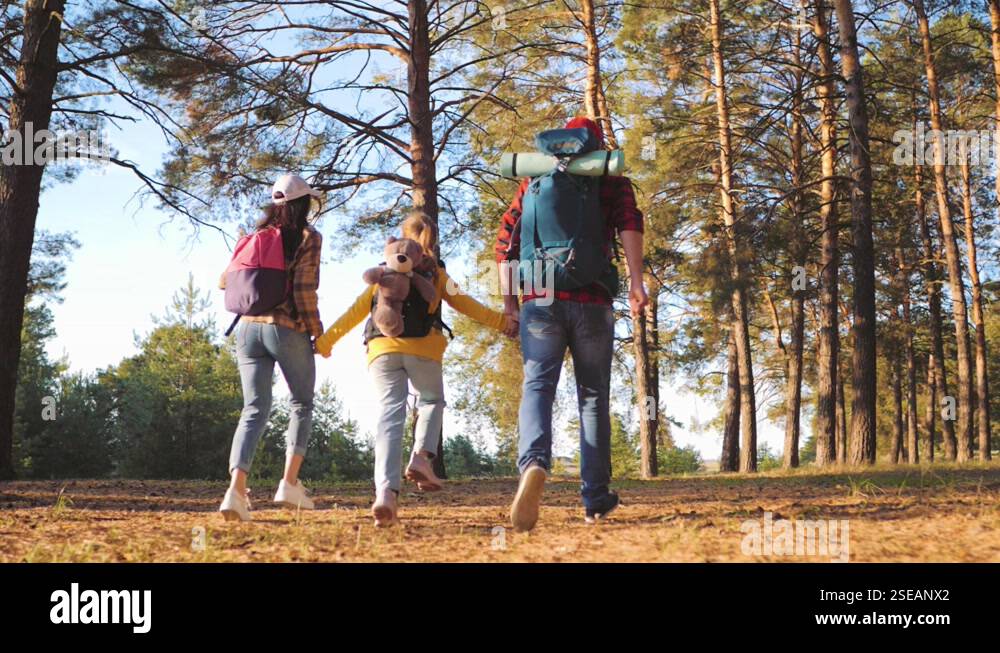 Happy family are running on hike trip. Teamwork family hiking in nature ...