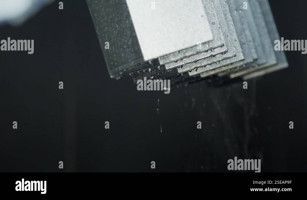Metal Plates are Hanging in the Air. Drops of Water are Falling Down ...