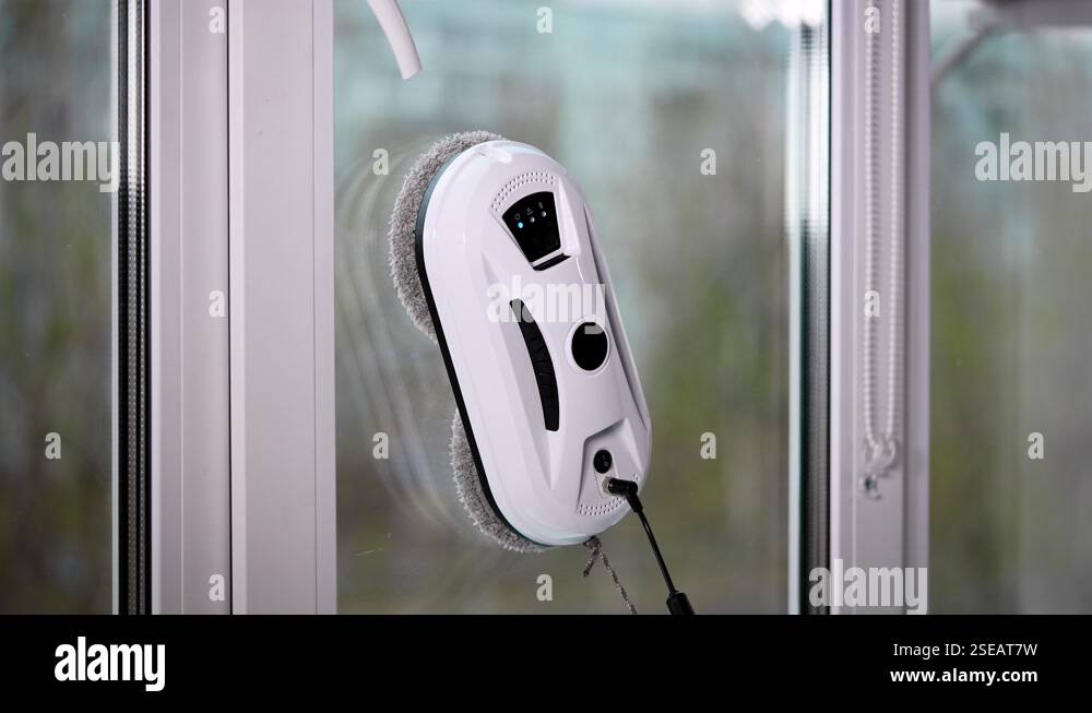 The automatic robot assistant washes the glass of the window. The robot ...