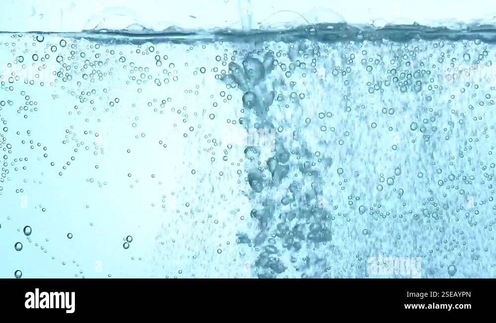 Extreme close up background of pouring pure clear sparkling water with ...