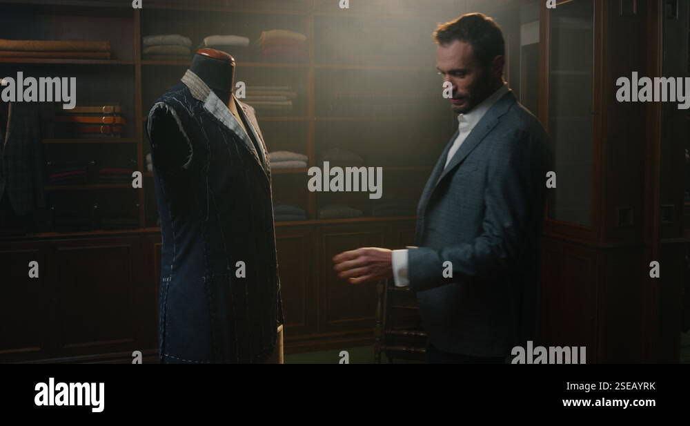 Tailor taking measurements of client for custom suit in tailoring ...