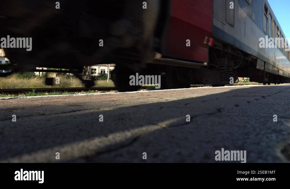 Running train view from below. A train pulls up to a platform slowing ...
