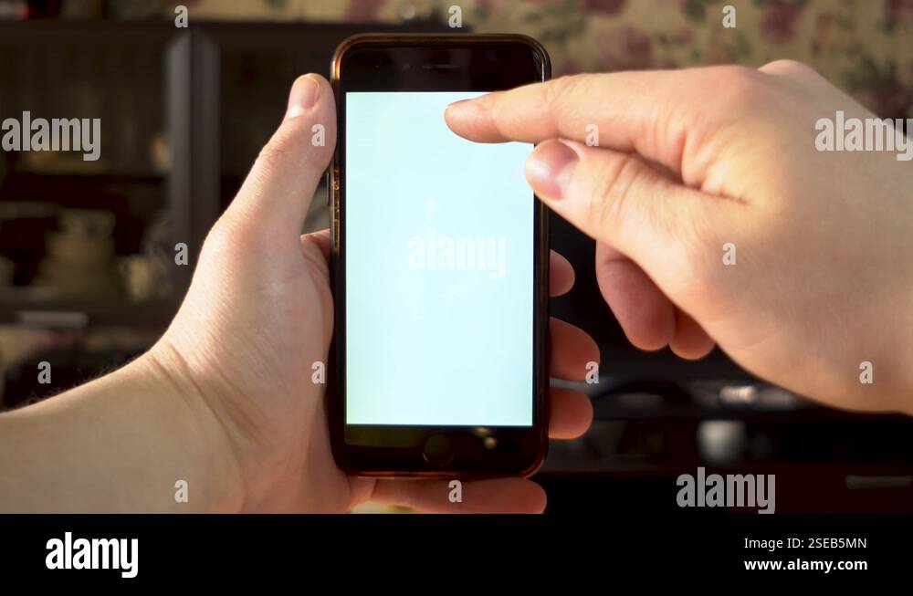 The man uses the phone. Hand makes swipe down on smartphone with white ...