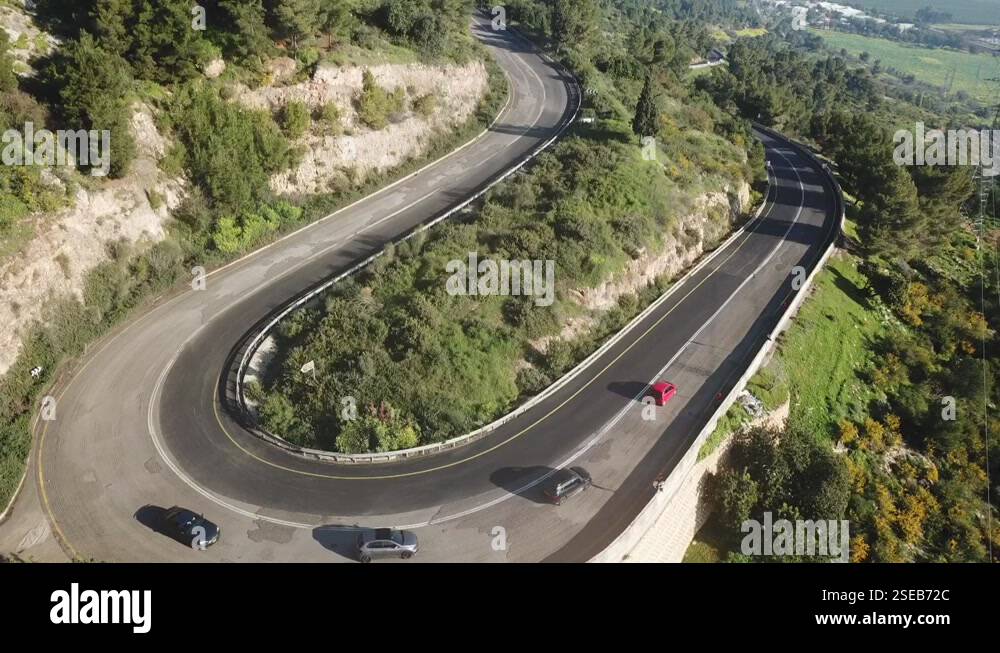 Cars turning left in a sharp curve Stock Video Footage - Alamy