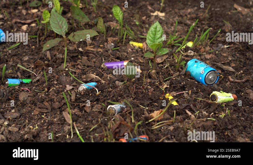 Dumping old batteries in landfills. Improper battery disposal. Soil ...