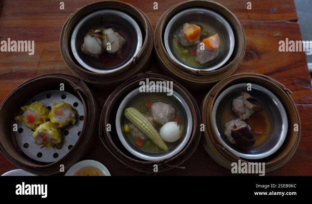Eating dimsim Chinese steaming food top view hand using chopsticks ...