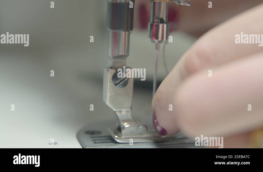 Close-up of a sewing machine needle sewing the fabric. sewing on the ...