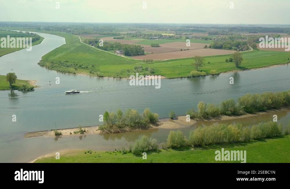 Aerial drone view of the beautiful river in the Netherlands and a boat ...