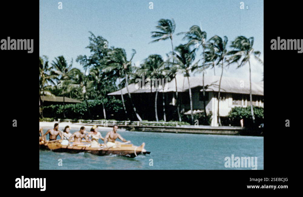 1950s: Outrigger canoe paddles past Royal Hawaiian Hotel, palm trees ...