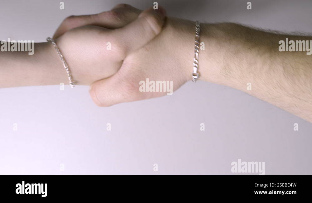 Two Hands Gripping Each Other Tightly In A Handshake. - Close Up Shot ...