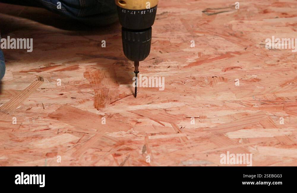 The man twists the screw screwdriver drill in the chipboard Stock Video ...