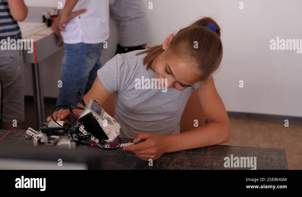 Children control cars robots assembled from a constructor in a robotics school Stock Video ...