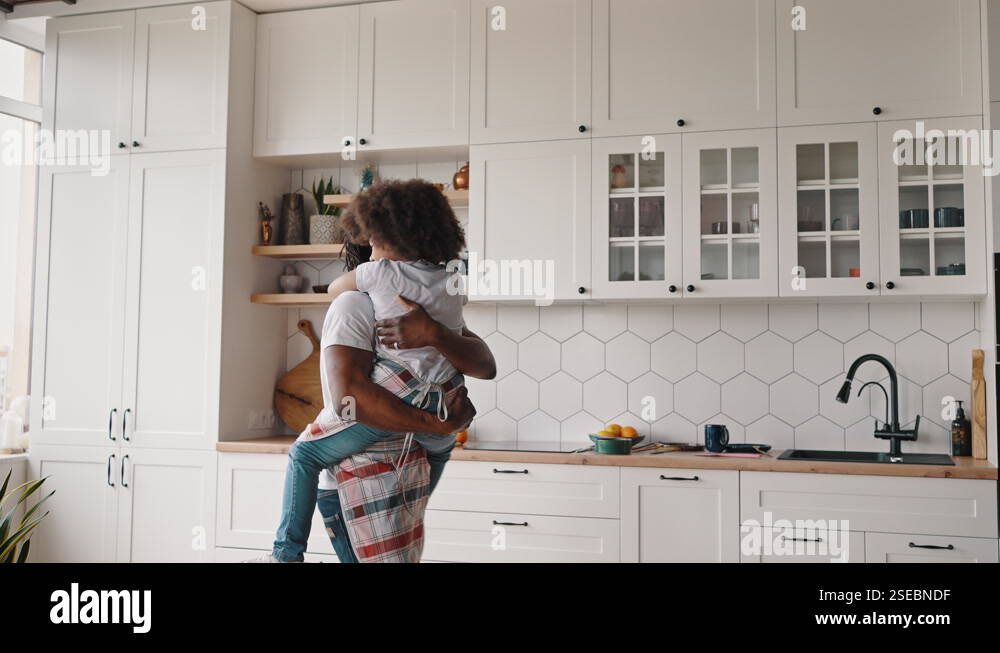 Love of dad and daughter. Cute african american man catching little kid ...
