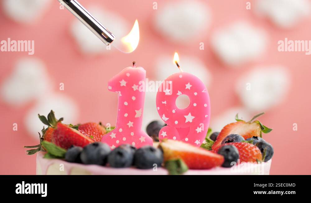 Birthday cake candle number 19. Candle and cake on pink background and ...
