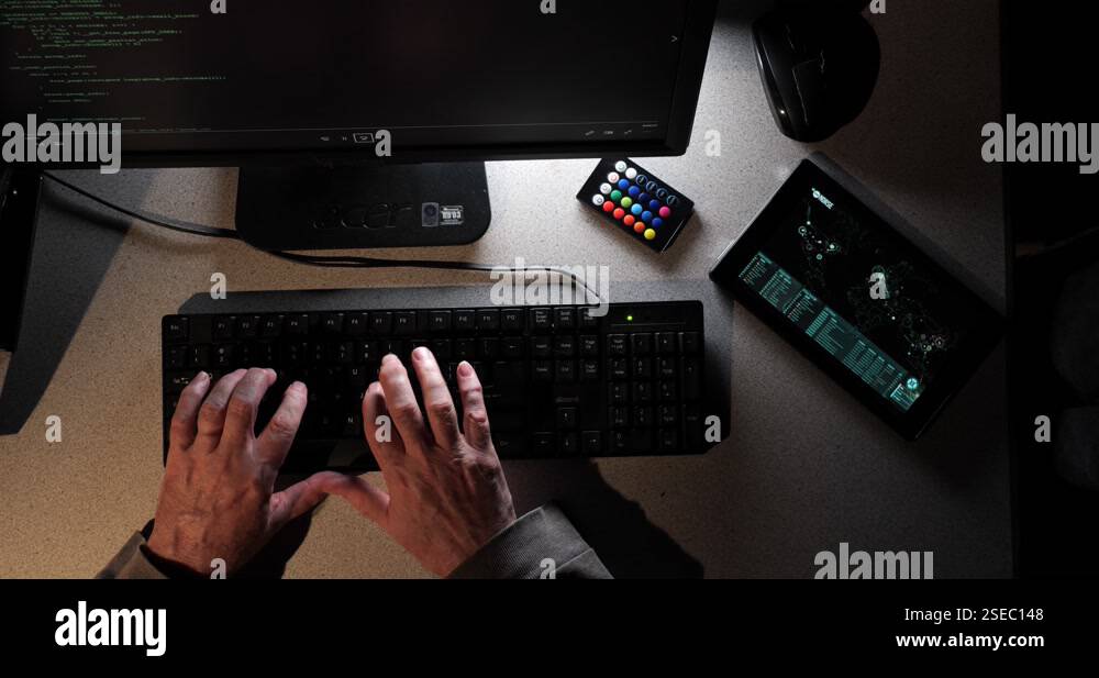 Hacker types as the overhead camera moves across their work area Stock ...