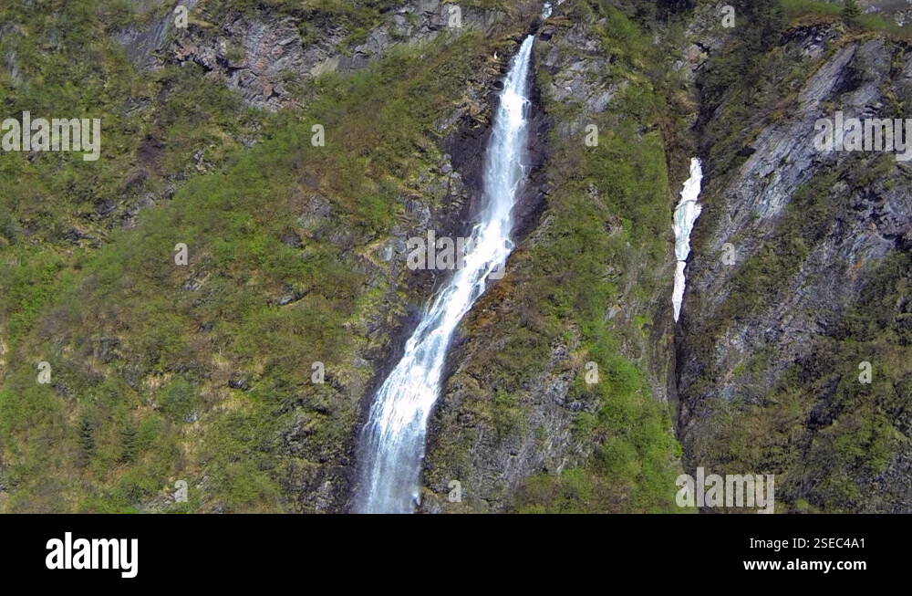 Lockdown Shot Of Waterfall Amidst Cliff During Winter - Denali, Alaska ...