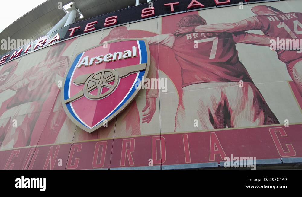 Emirates Stadium in London, Arsenal FC badge low aerial Stock Video ...