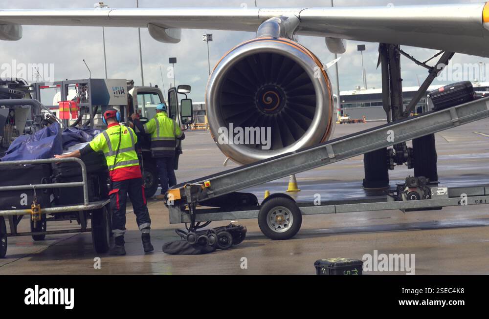 Footage of airport baggage handler ramp agent loading the baggages ...