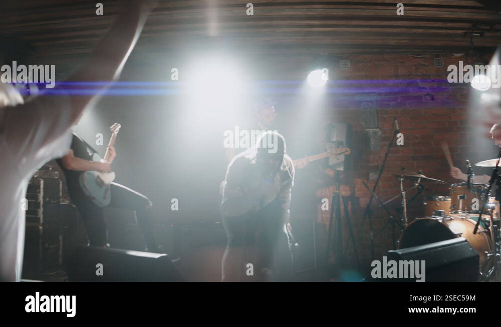 WIDE Punk rock band playing music during their concert on a stage of ...