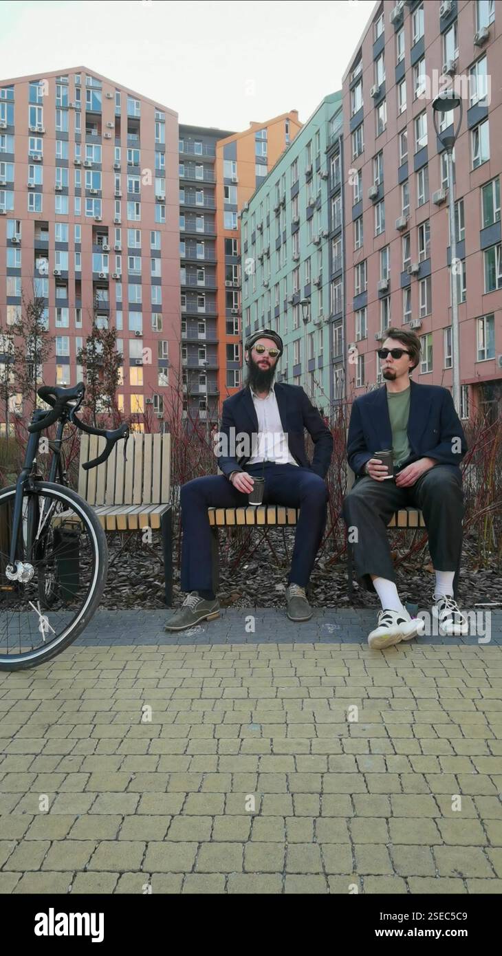 Two young men friends dressed casually spending time together at the ...