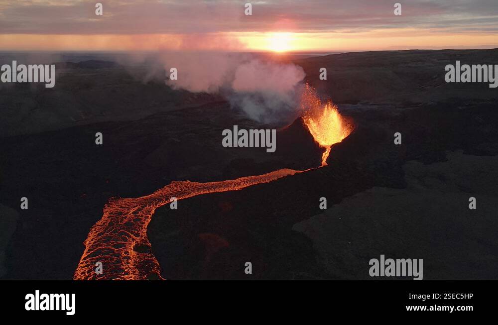 Magma spurts from crater fissure of erupting volcano with sunset in ...