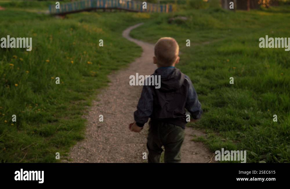 Authentic cute 1 little preschool baby boy walking and run along path ...