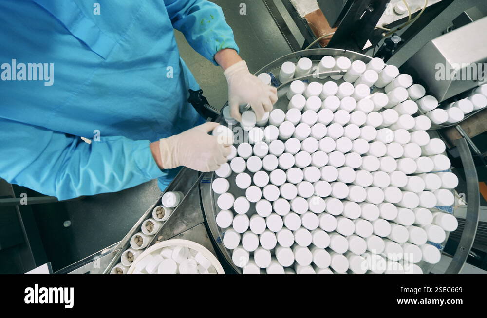Pharmaceutical factory production line. Pill tubs are getting relocated ...