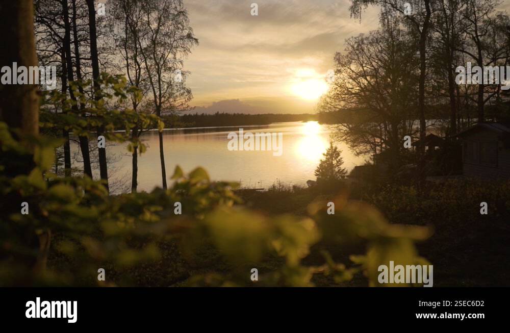 Sunset over a lake in the north. camera movement backwards along some ...