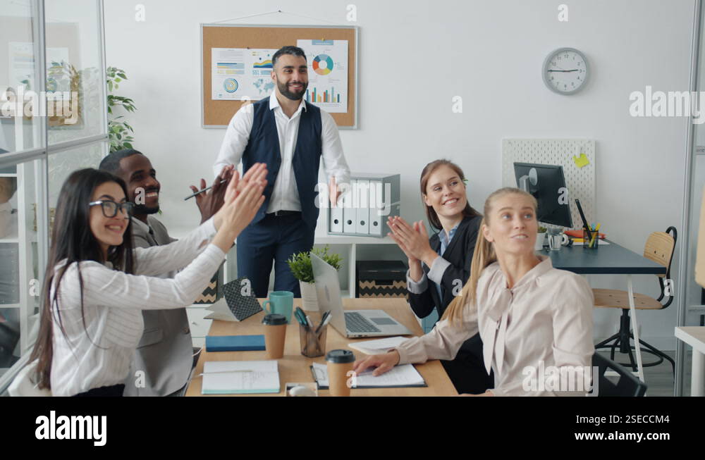 Group of employees greeting new worker with carton box clapping hands ...