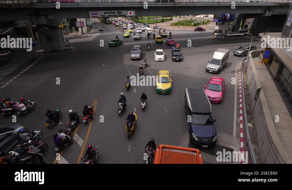 Cars and motorbike traffic flow at ground level of Sala Daeng ...