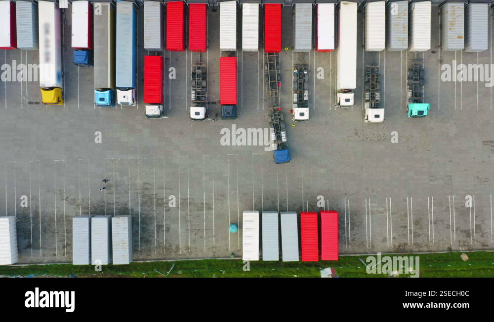 Semi-trailer trucks stand at warehouse ramps for load and unload goods ...