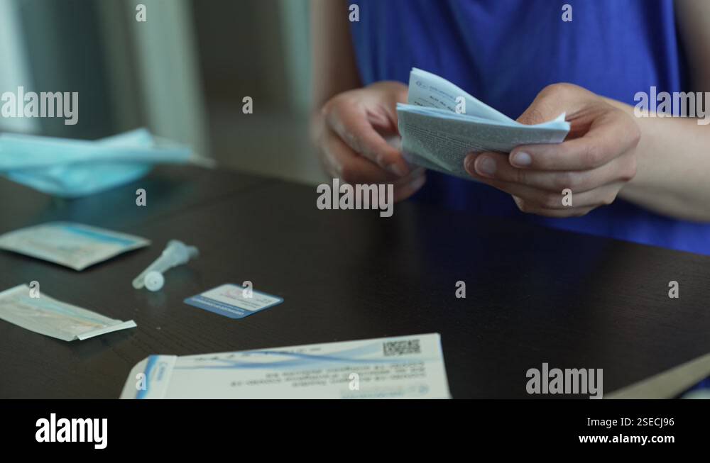 COVID-19 Antigen Rapid Test Kit - Woman Unfolding And Reading The ...