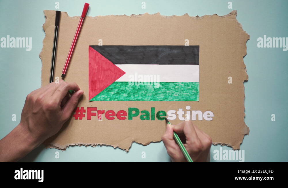 Hand a man coloring a banner Palestine flag and text of the "Free ...