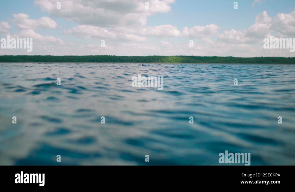Closeup of clean water flowing in the river. Flow creating glints, and ...