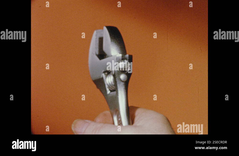 1950s: Hand turns dial on adjustable wrench. Worker inserts wrenches ...