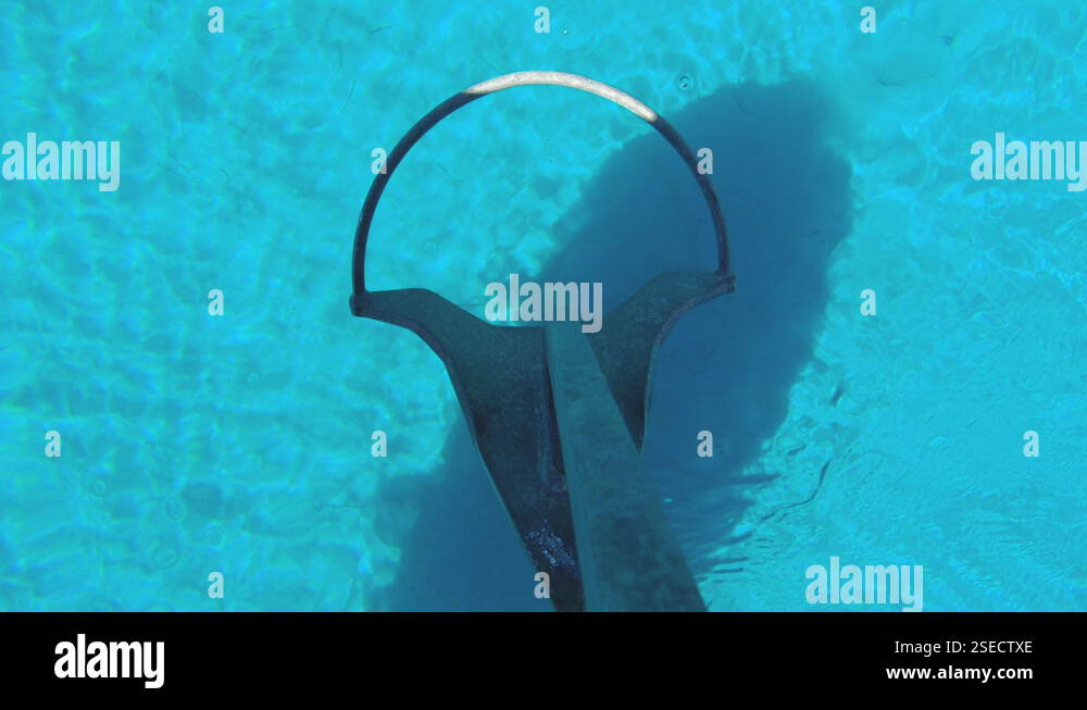 Slow motion - Anchor dropped into the sea and landing on the sandy sea ...