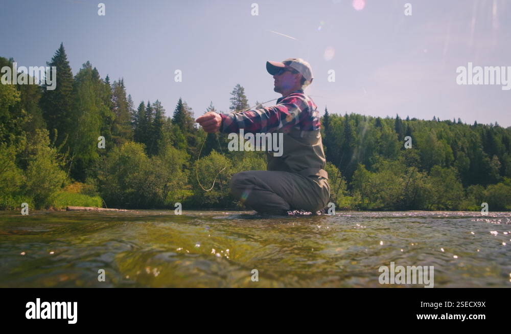 Fly fishing. Man fishing on the river on fly. Male caucasian angler ...