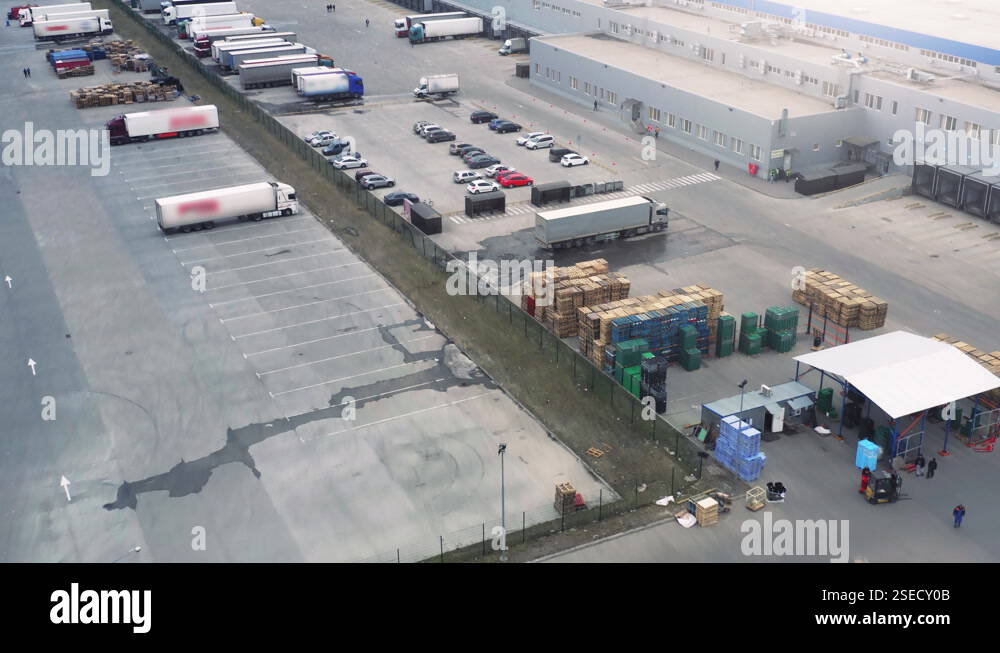 Logistics park with warehouse and outside storage of wooden pallets ...