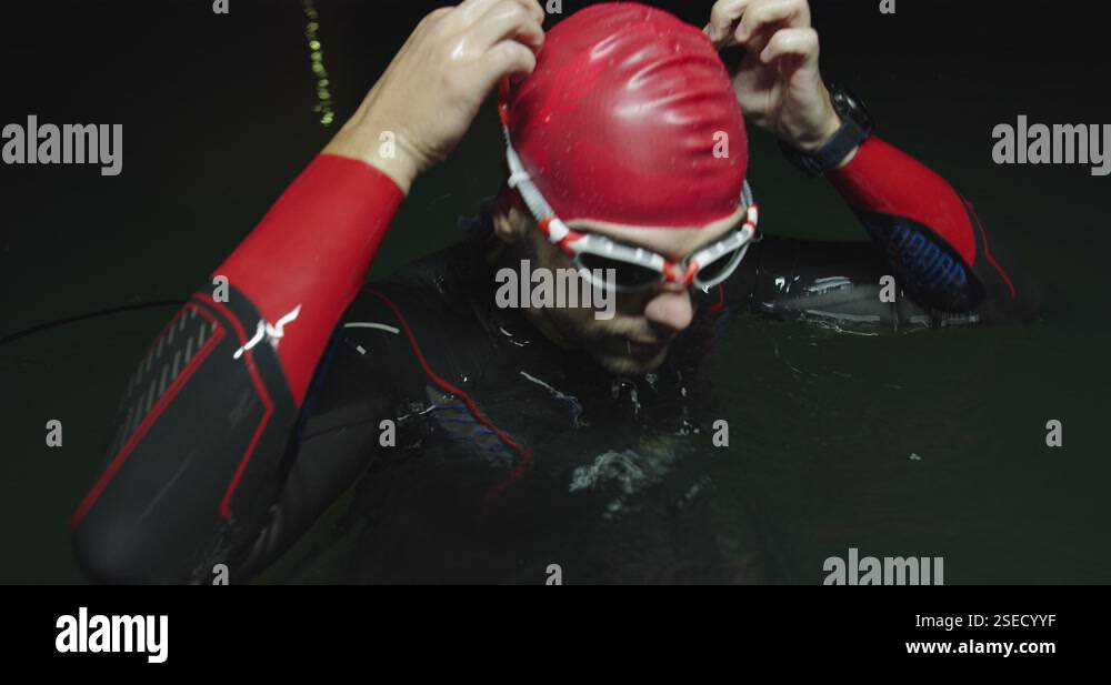 Portrait of triathlon athlete swimmer having a break during intense ...