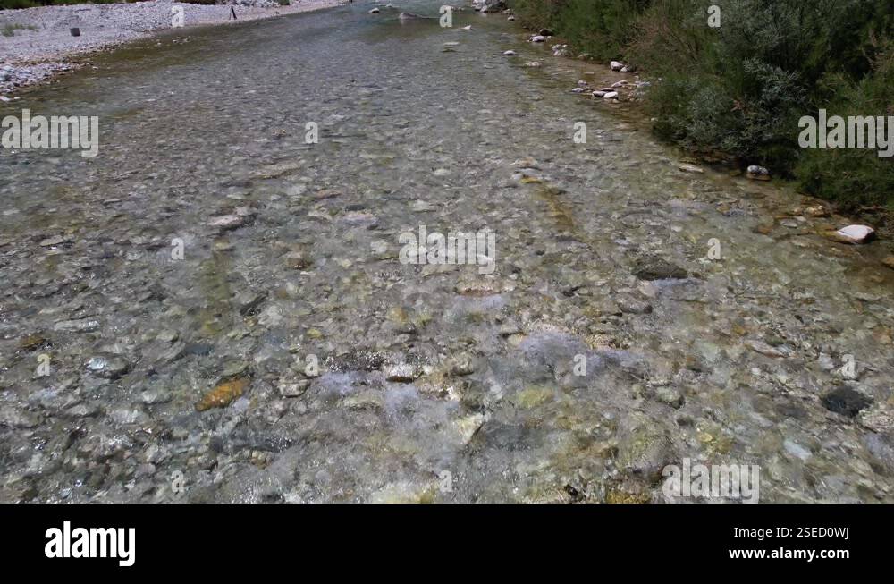 Riverbed texture with clean transparent water of mountain river ...