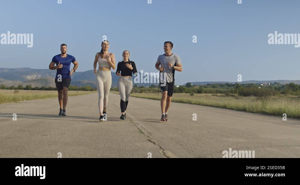 Multiethnic group of athletes running together on a panoramic ...