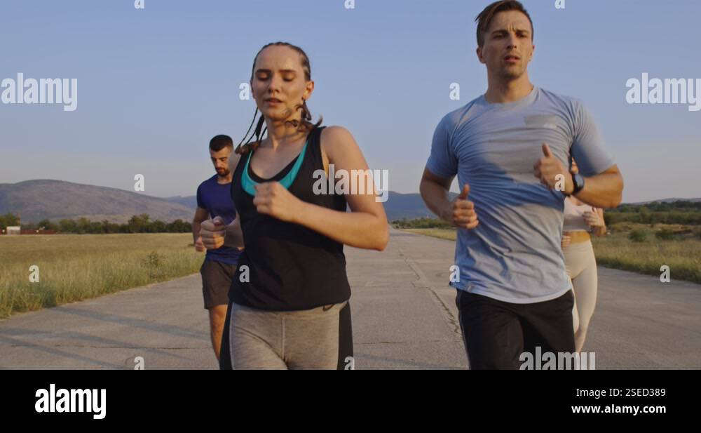 Multiethnic group of athletes running together on a panoramic ...