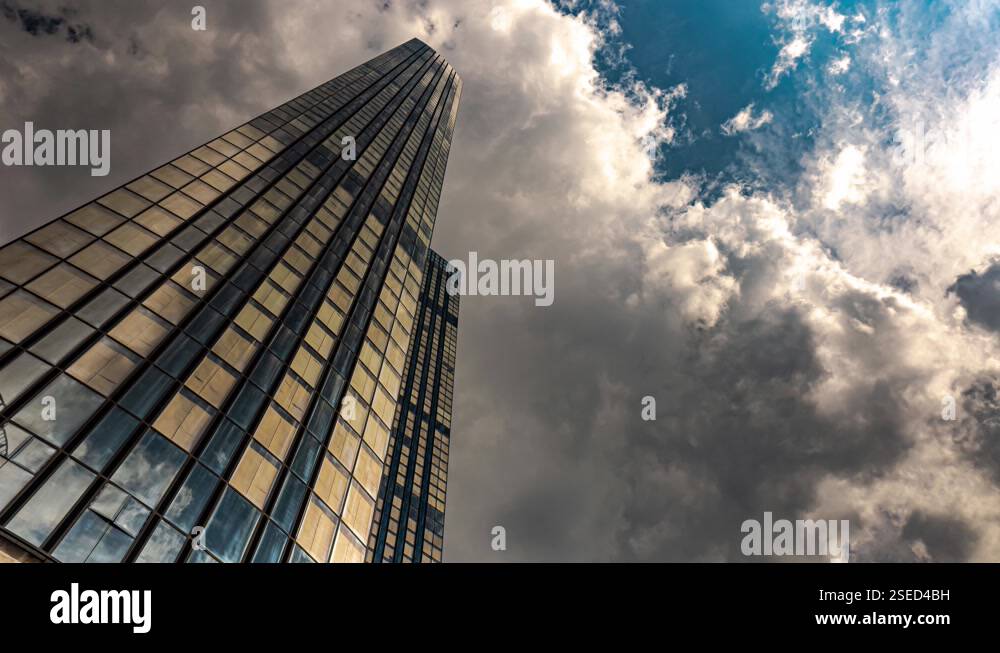 bottom-up view of rotating skyscrapers and flying clouds, hyper lapse ...