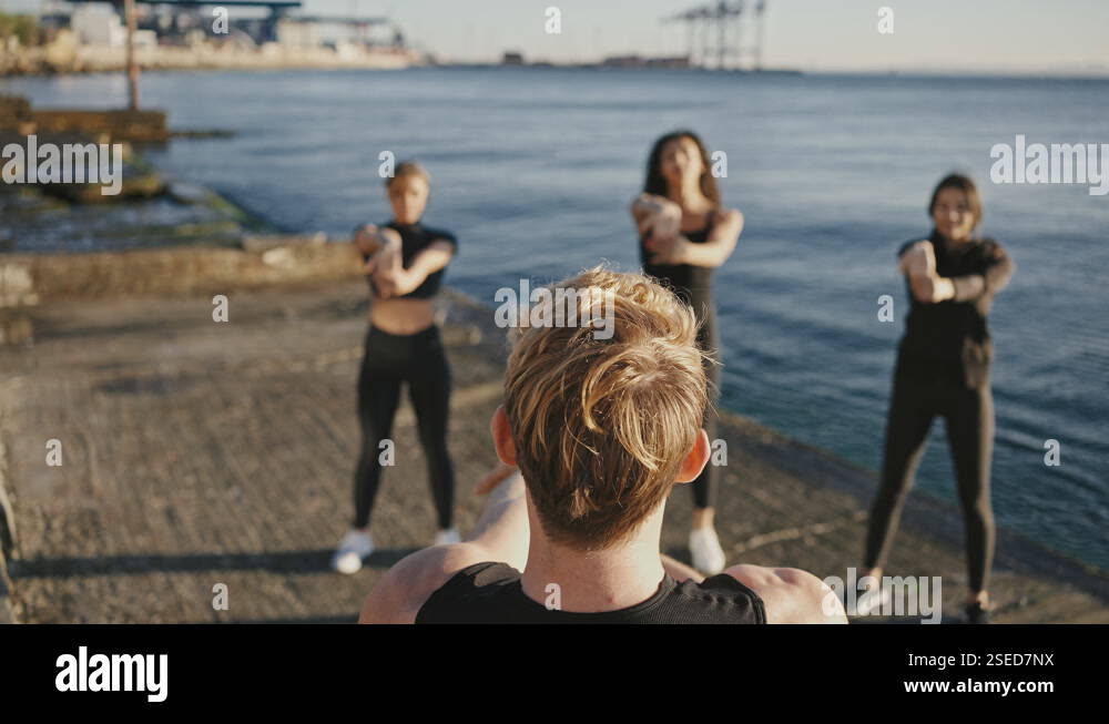 Three diverse women practicing workout at seaside, repeating exercises ...