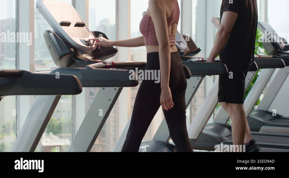 Young Chinese couple running on treadmill at gym,4K Stock Video Footage ...